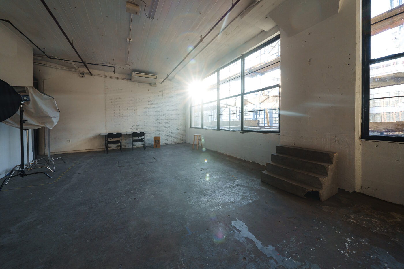 Photo studio with exposed brick and concrete wall available for rent in NY